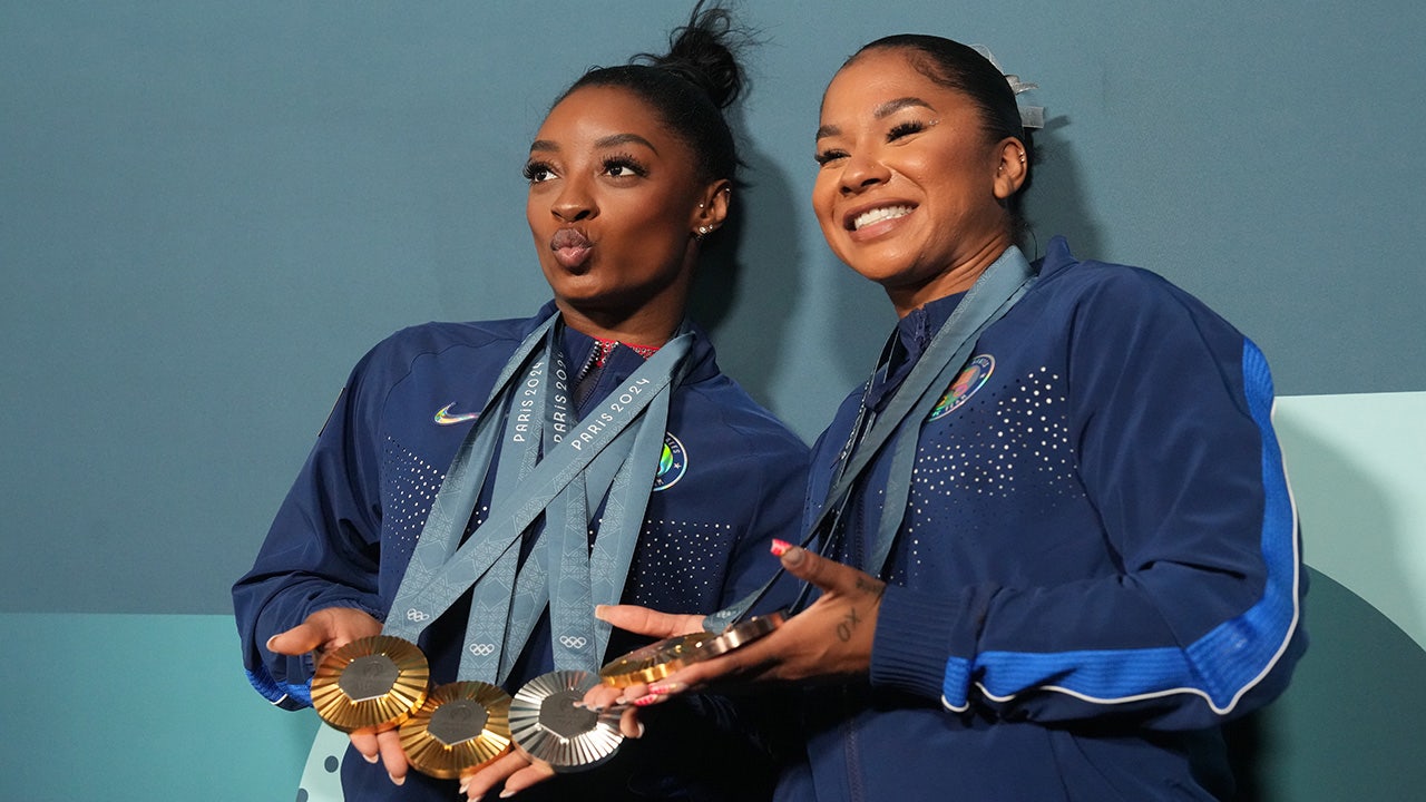 Simone Biles and Suni Lee stand by Jordan Chiles during the Paris ...